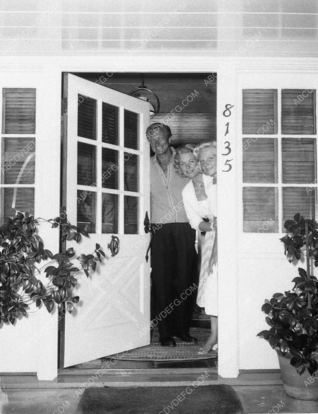 candid Richard Denning w wife and daughter looking out the front door ...