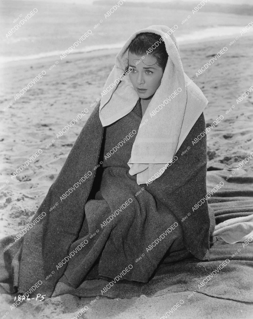 crp-03767 1957 photo Marianne Cook huddles in a blanket on beach film ...